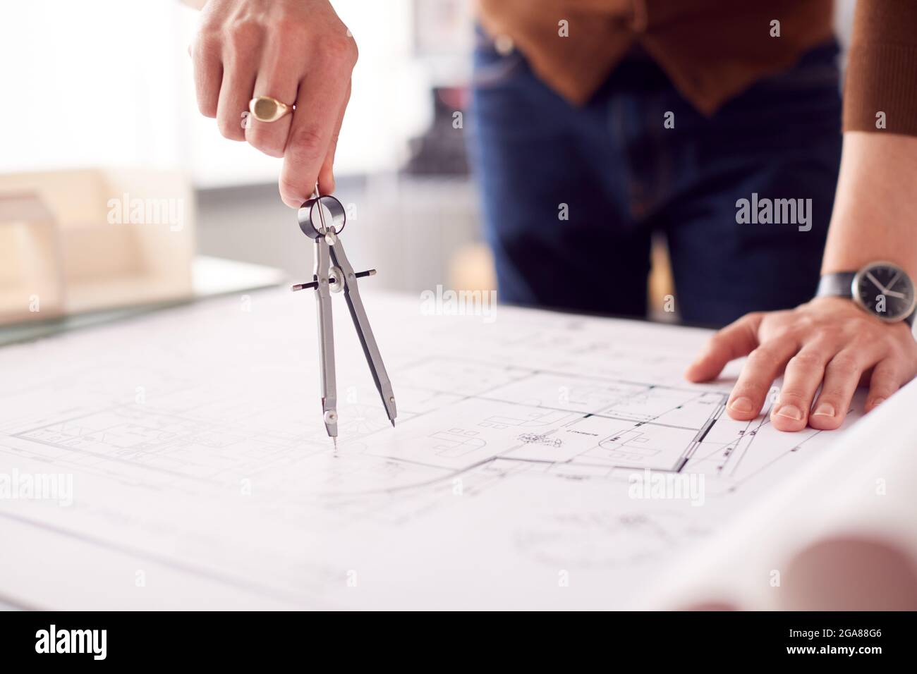 Close Up Of Male Architect In Office Measuring Plan Or Blueprint Using ...