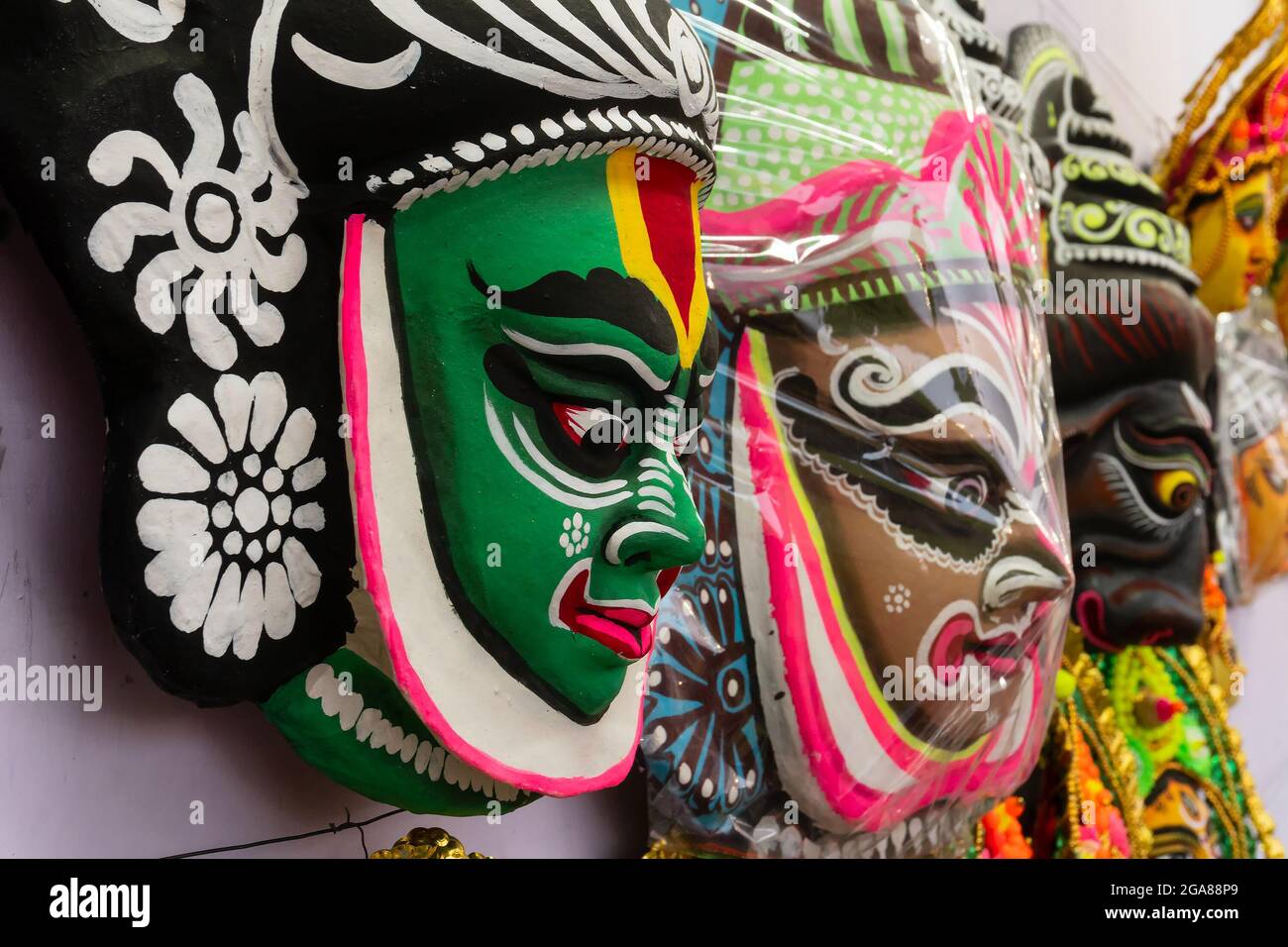 Colorful chhou masks of men on display for sale at handicrafts fair ...