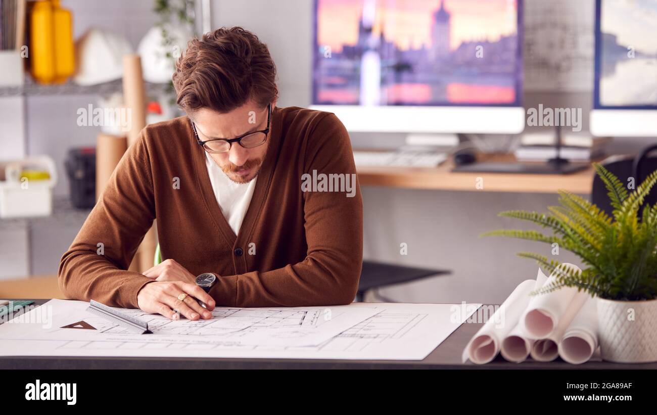 Professional male studying at desk hi-res stock photography and images ...