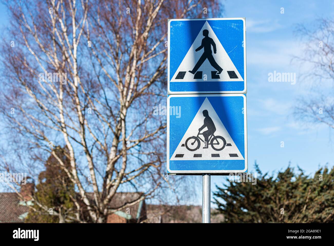 Sign showing pedestrian and bike path crossing Stock Photo - Alamy