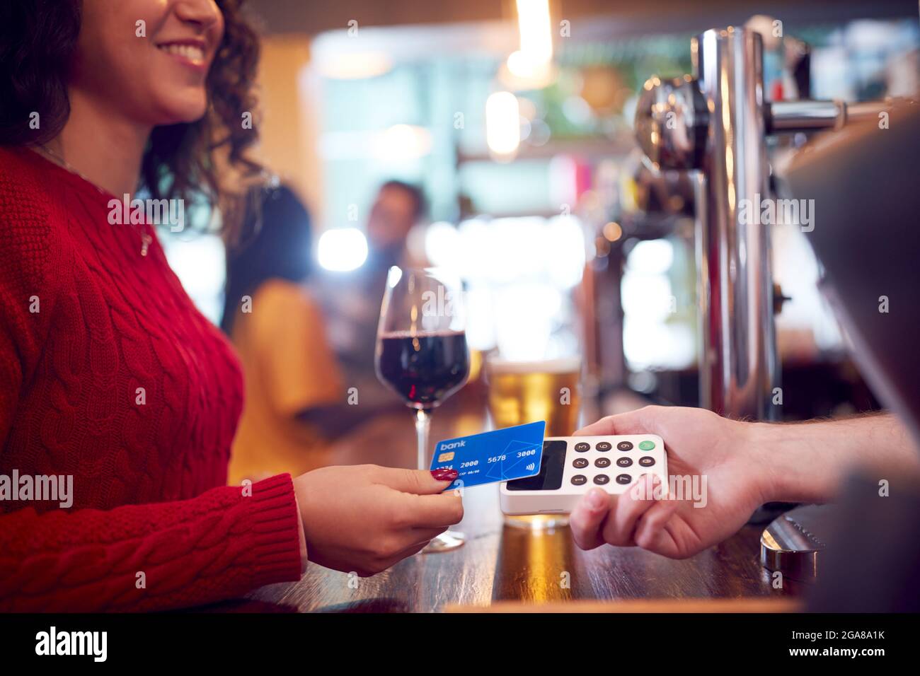 Person paying for drinks credit card hi-res stock photography and ...