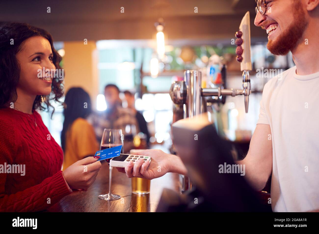 Woman paying for drinks at bar card hi-res stock photography and images ...