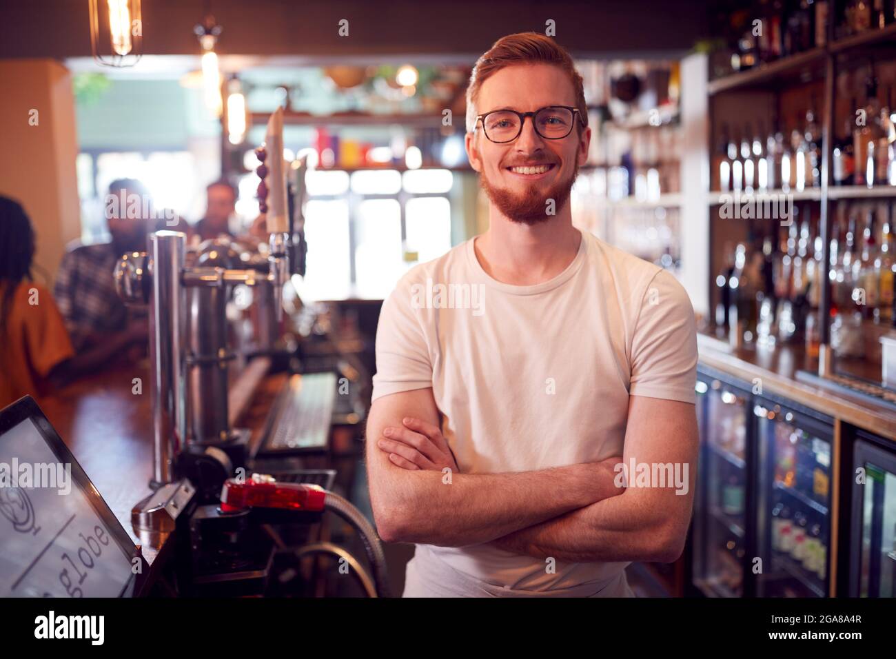Portrait Of Smiling Male Bar Owner Standing Behind Counter Stock Photo ...