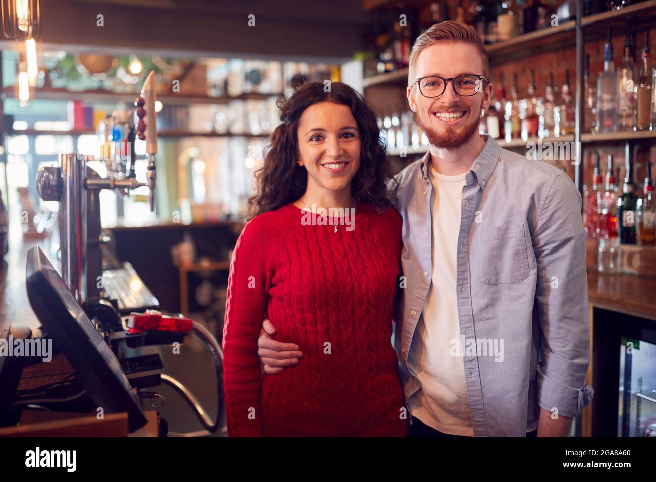 Portrait Of Smiling Couple Owning Bar Standing Behind Counter Stock ...