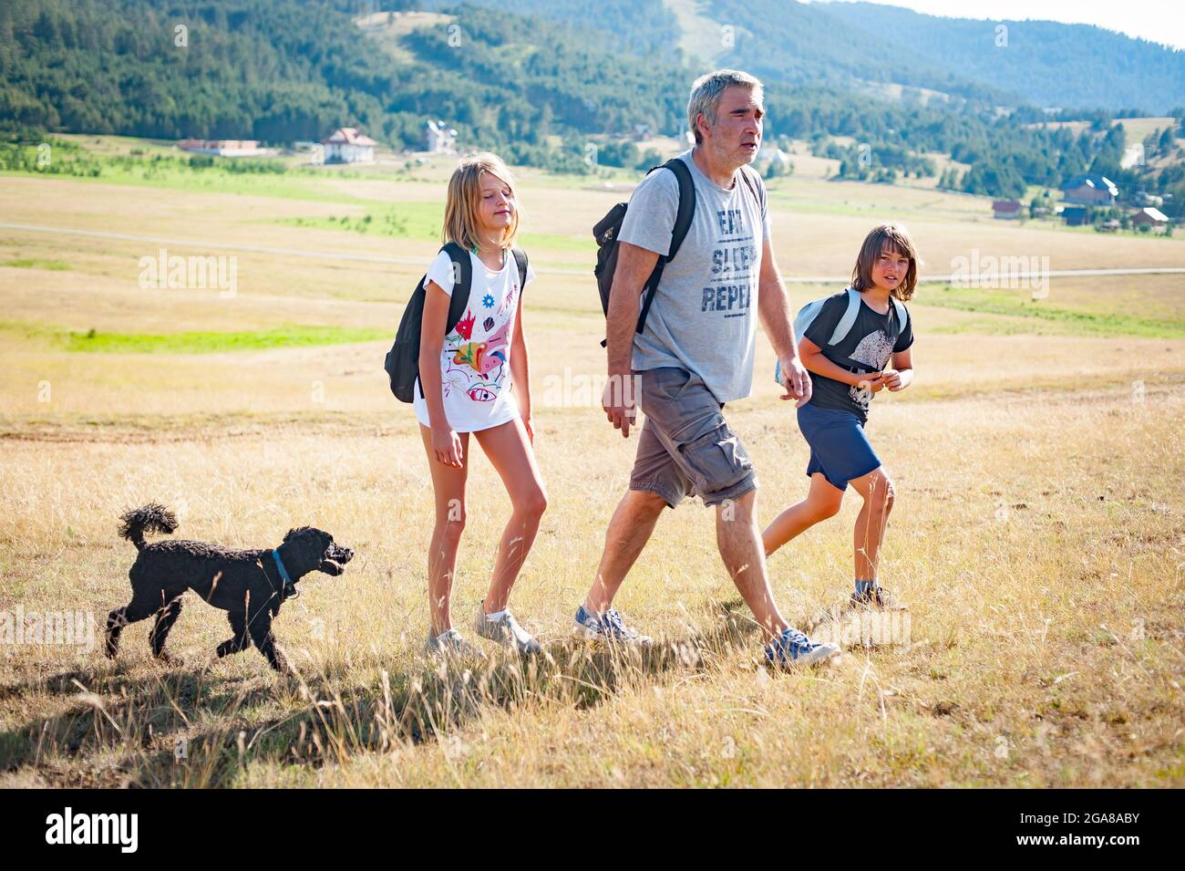 Family in Nature. Happy family spending time together outside in green ...