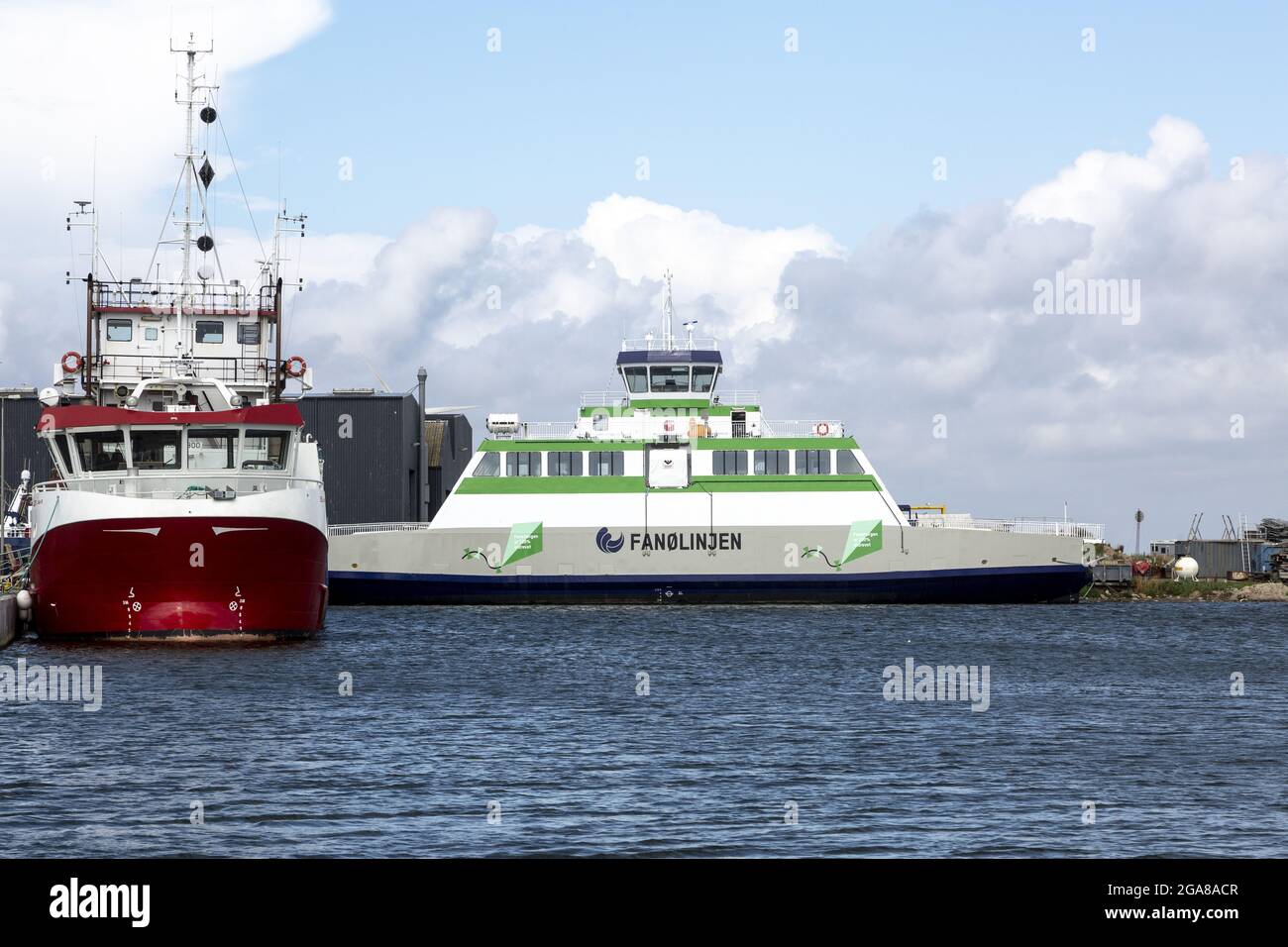 Hvide Sande harbor and Hvide Sande Shipyard. Moored at the quay is a ...