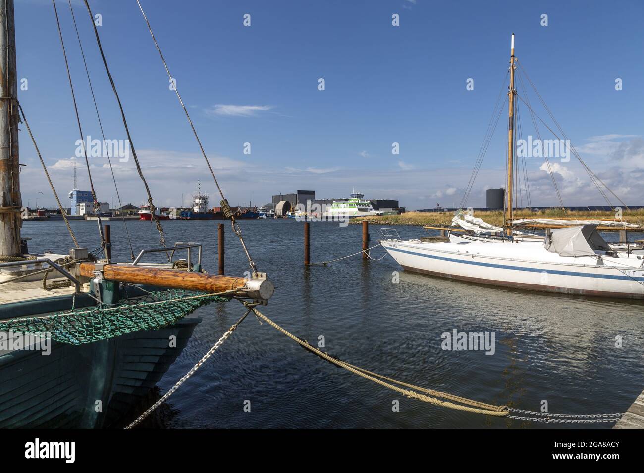 Hvide Sande harbor and Hvide Sande Shipyard. Moored at the quay is a ...