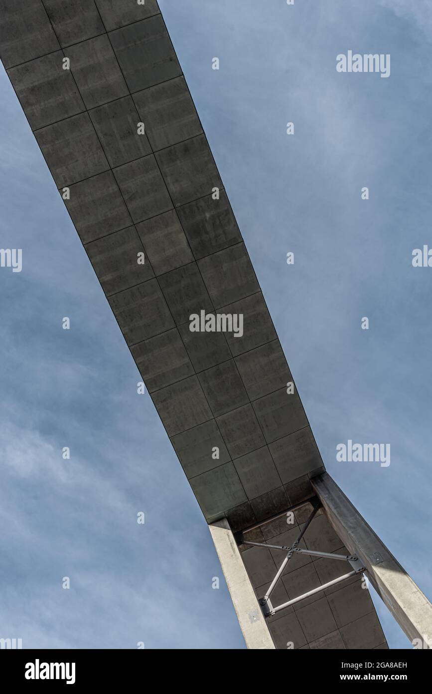 Underside of a concrete walking bridge between buildings Stock Photo ...
