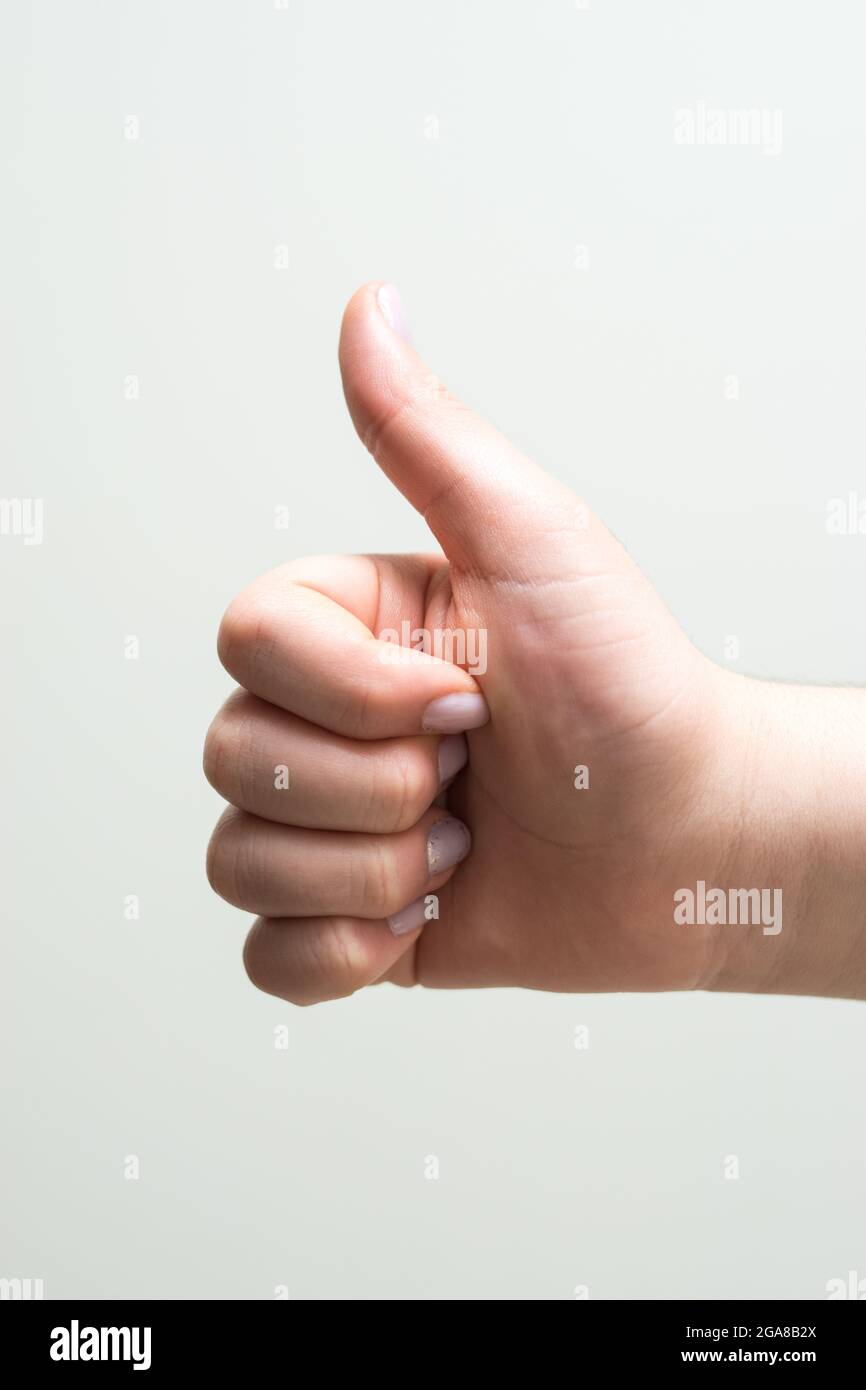 Hand raising the thumb, making a symbol of success Stock Photo - Alamy