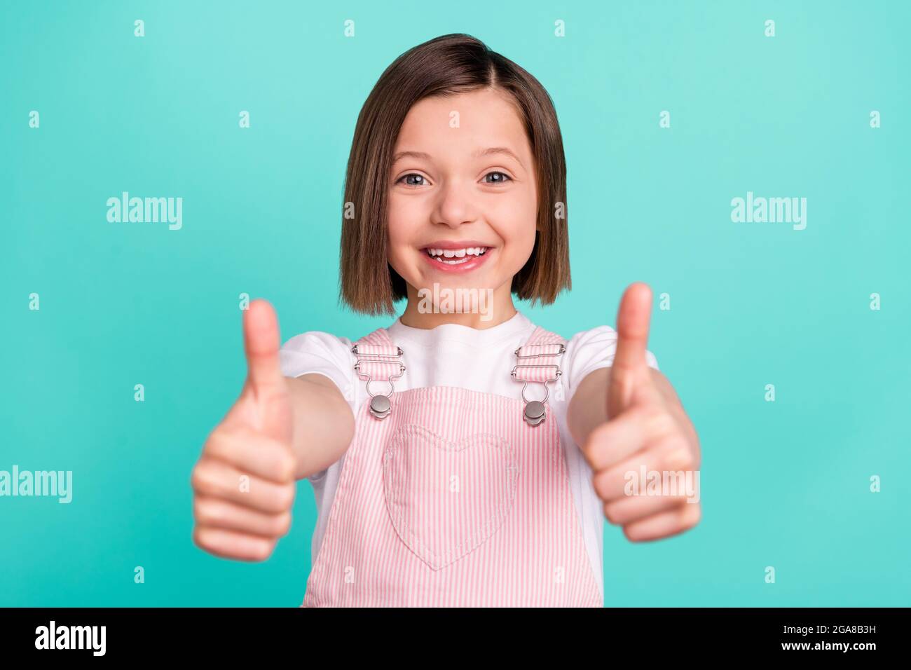 Photo of cheerful happy nice little girl give thumbs up you good job ...