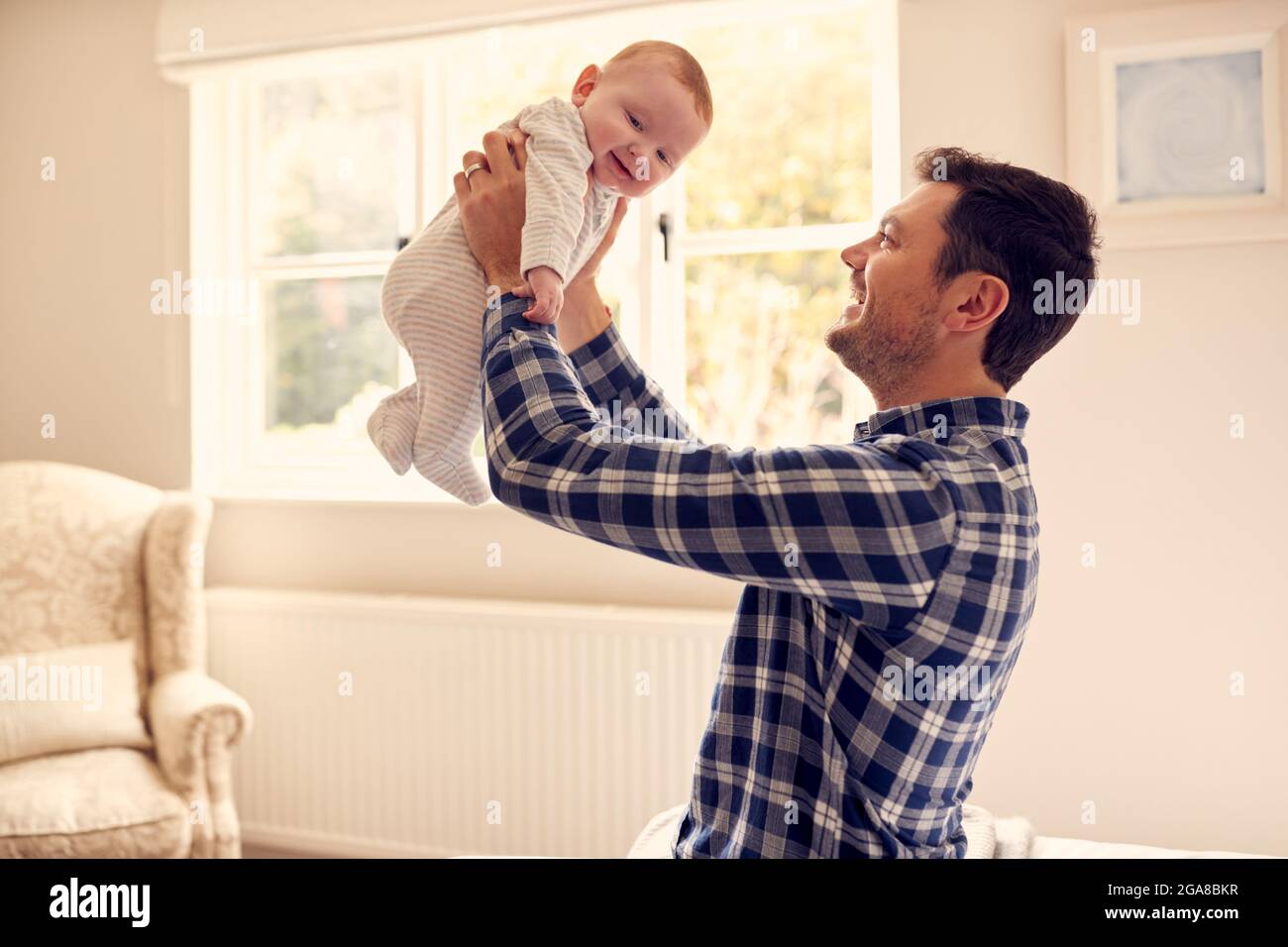 Father holding baby in air indoors hi-res stock photography and images ...