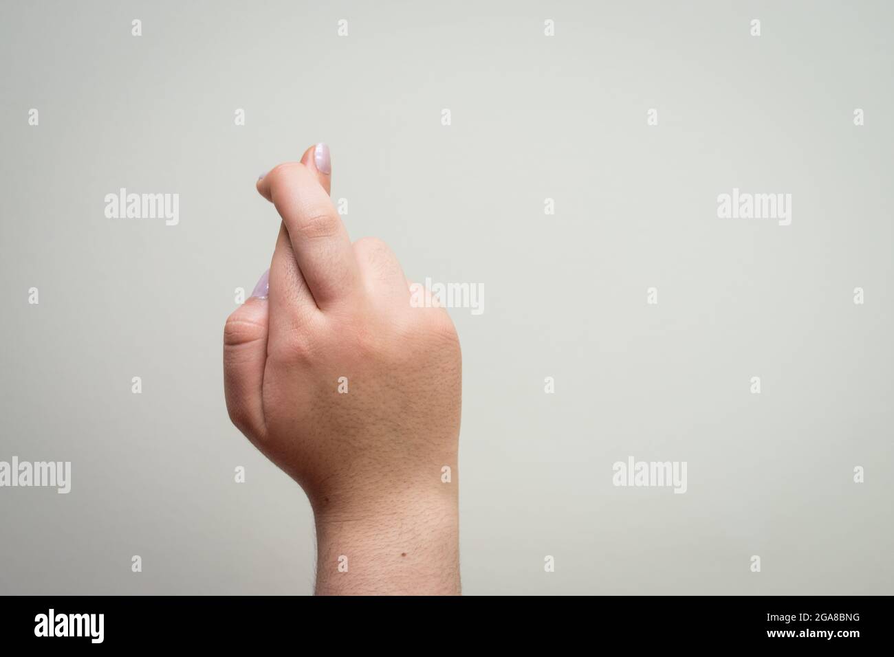 Intertwining fingers, making a symbol of hope Stock Photo - Alamy