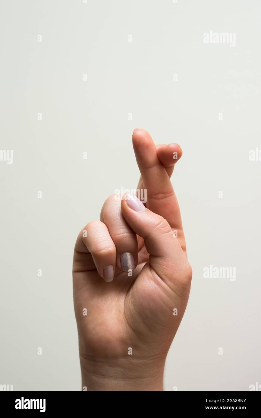 Intertwining fingers, making a symbol of hope Stock Photo - Alamy