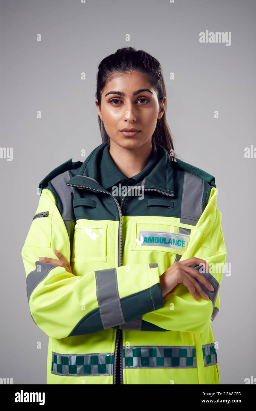 Studio Portrait Of Serious Young Female Paramedic Against Plain ...