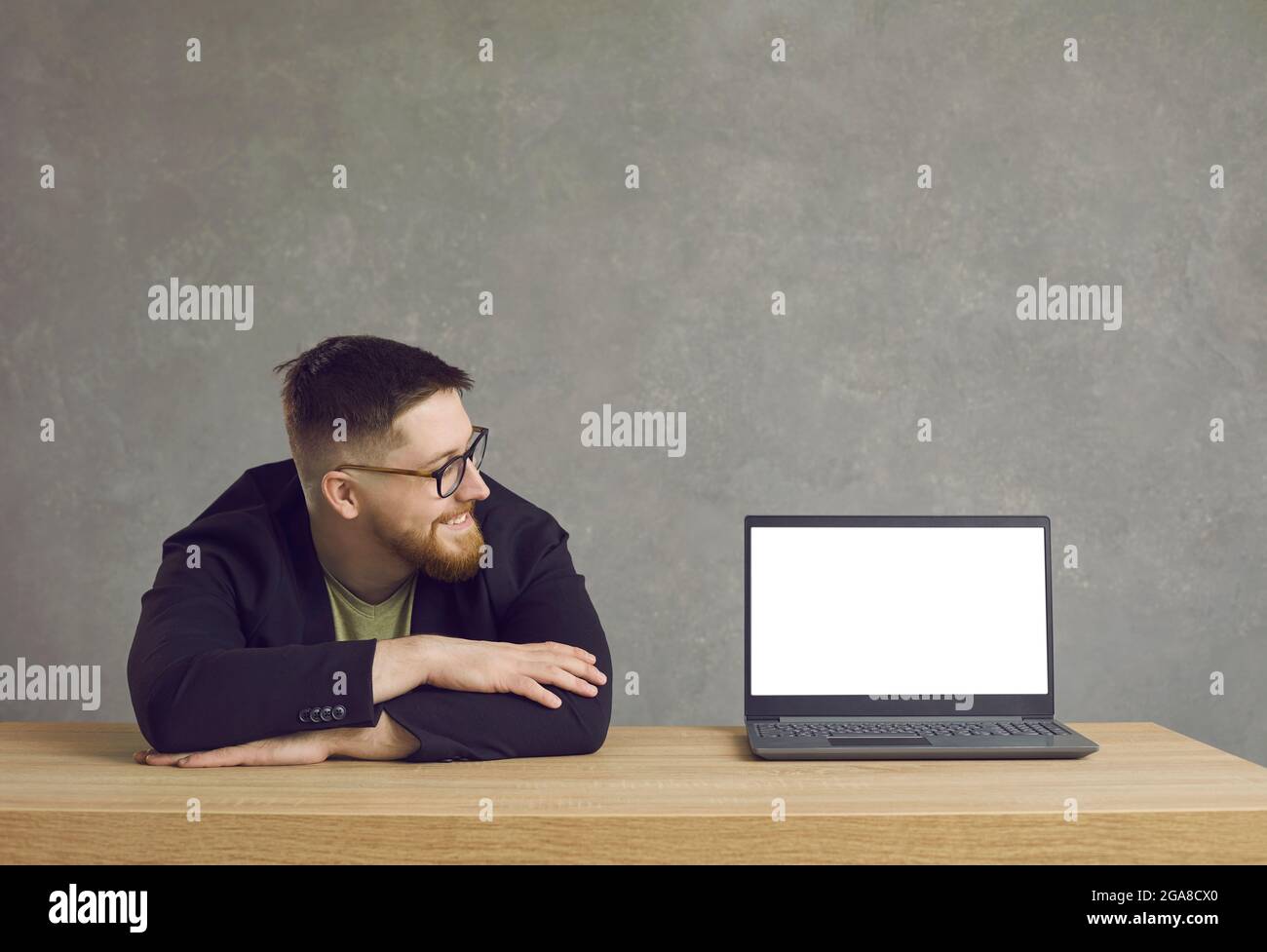 Happy young man looking at blank white mockup screen of his modern ...