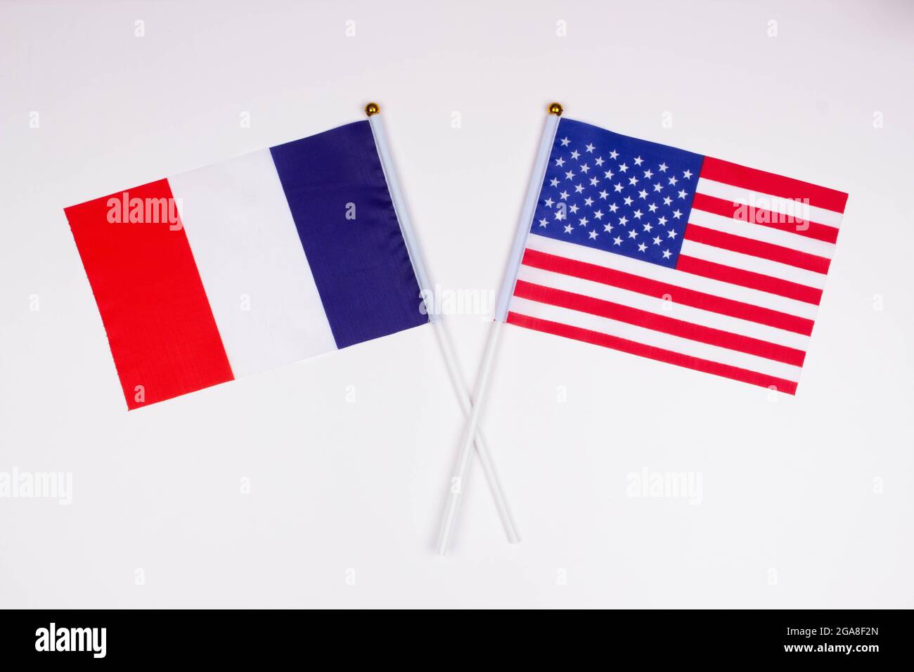 Flag of France and flag of USA crossed with each other on a white ...