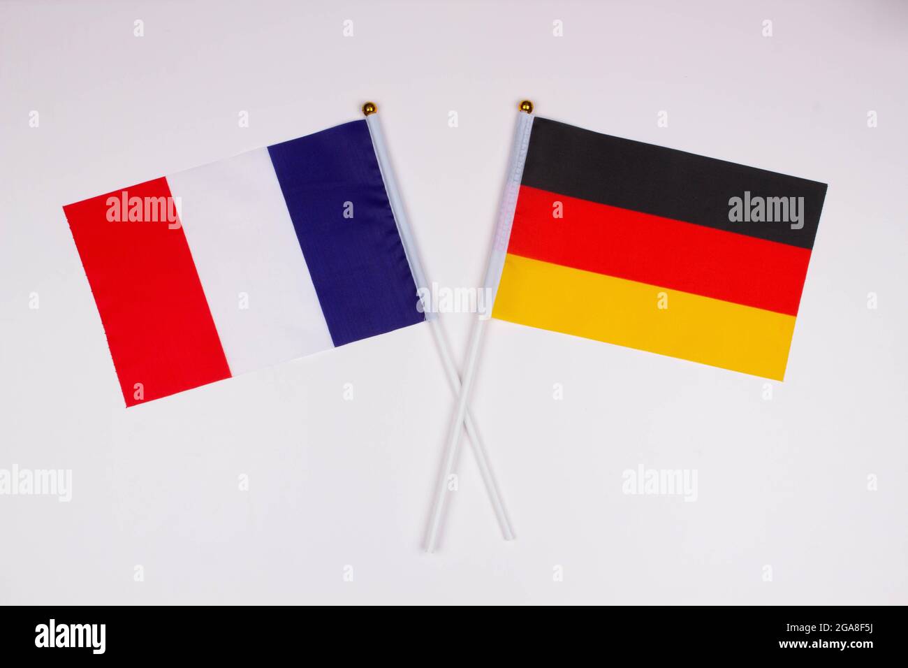 Flag of France and flag of Germany crossed with each other on a white ...