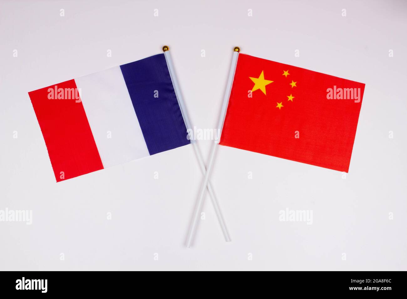 Flag of France and flag of China crossed with each other on a white ...