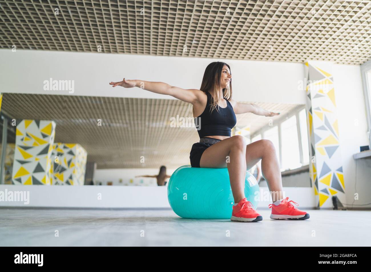 Low angle shot of a girl on an exercise ball Stock Photo - Alamy