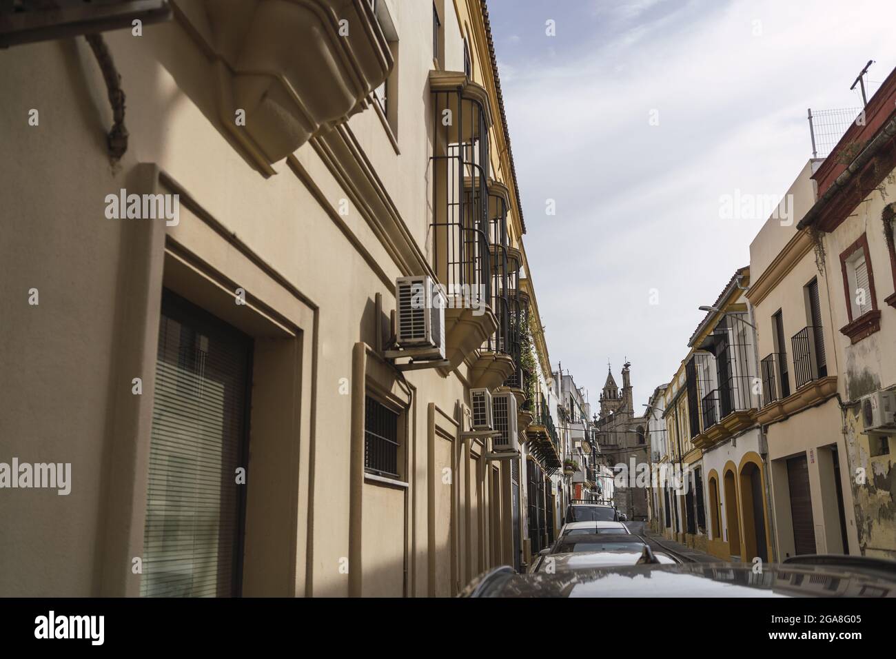 Narrow street with cream stone buildings from both sides Stock Photo ...