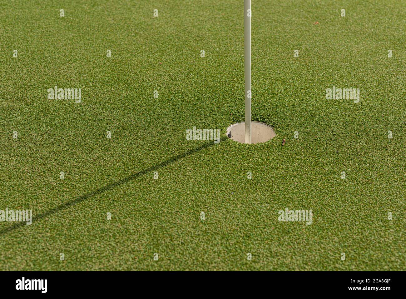 Pin and hole of a minigolf course Stock Photo - Alamy