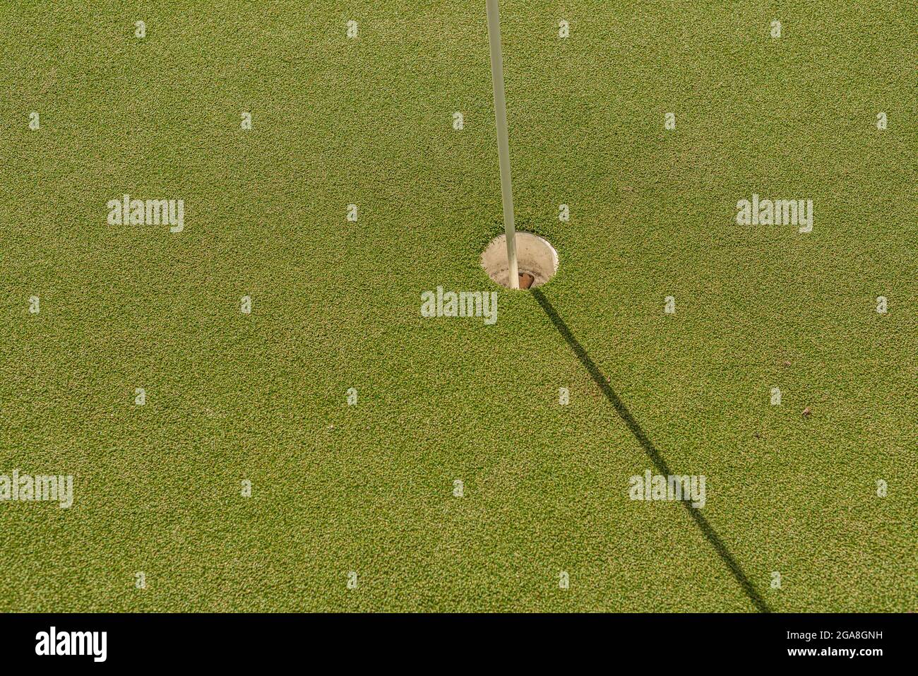 Pin and hole of a minigolf course Stock Photo - Alamy