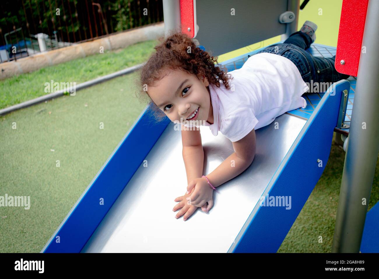Little Latina girl playing in the park outdoors Stock Photo - Alamy