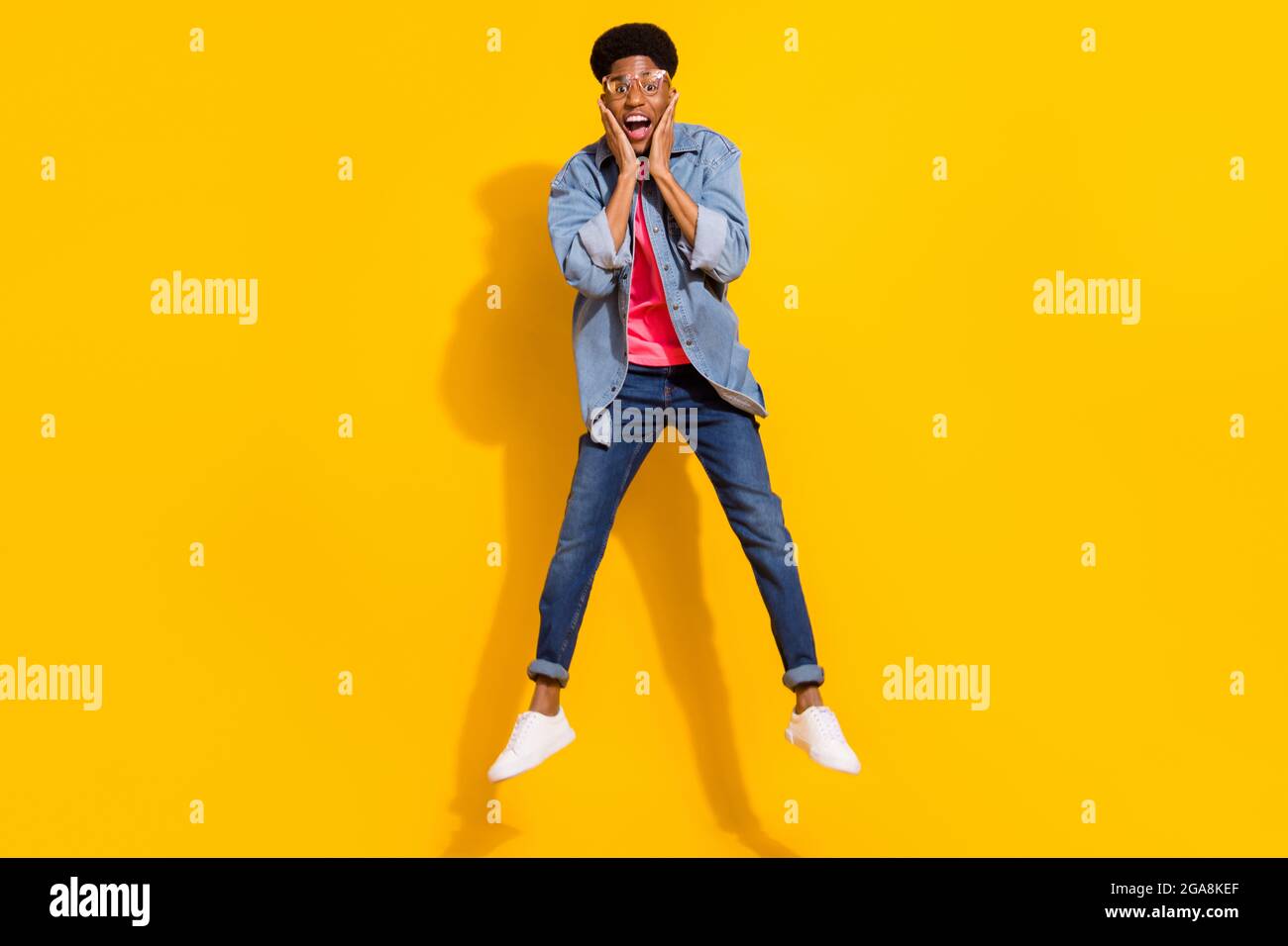 Full body photo of crazy happy afro american man jump up raise hands ...