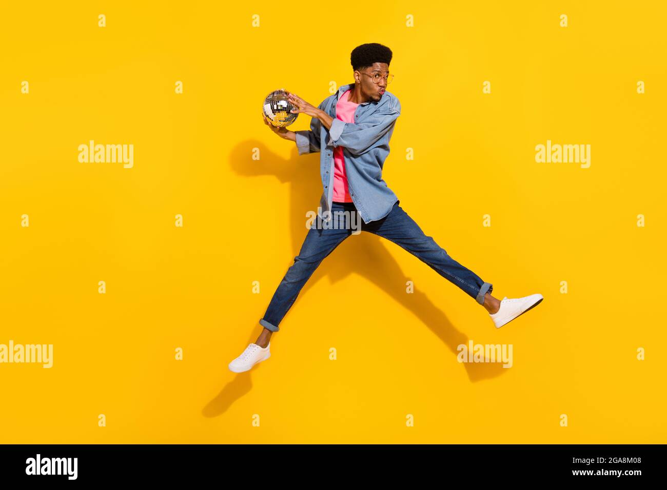 Full size photo of happy dark skin man wear denim shirt hold disco ball ...