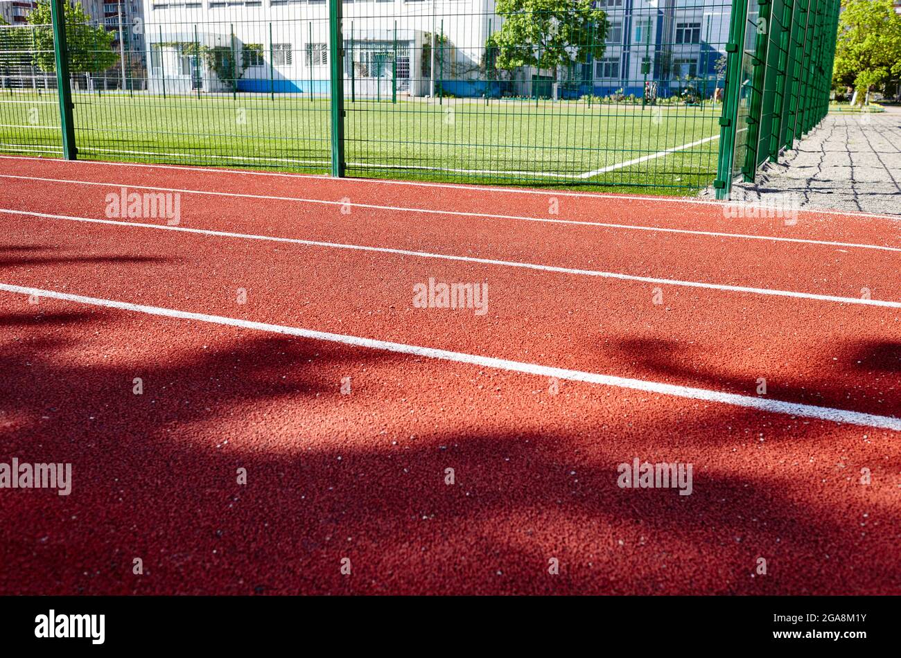 Red treadmill on sport field. Running track on the stadium Stock Photo ...
