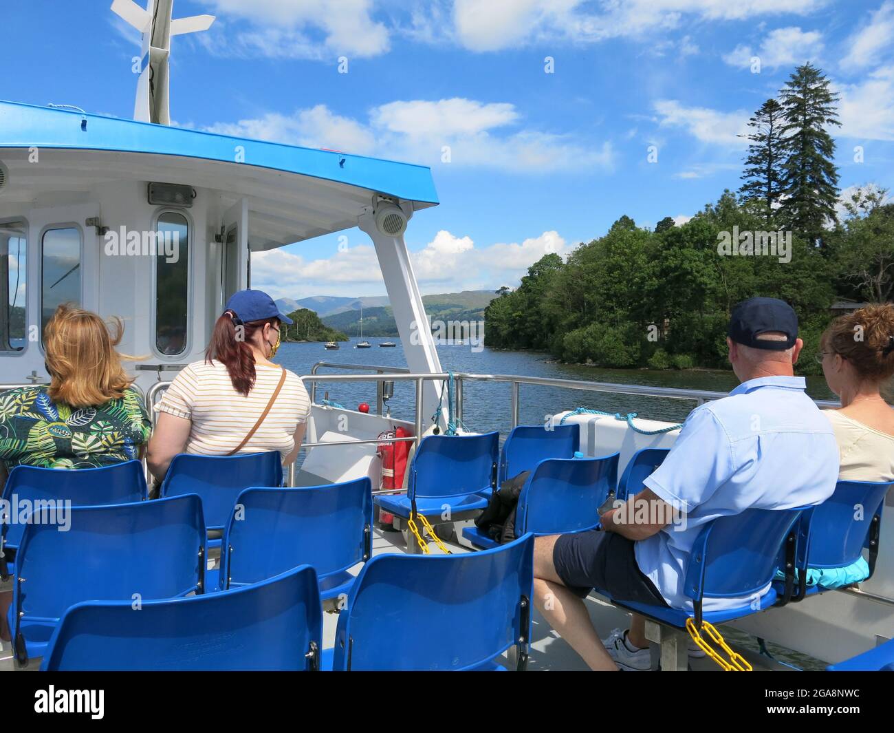 Passengers sitting on the top deck of a leisure cruise on Lake ...
