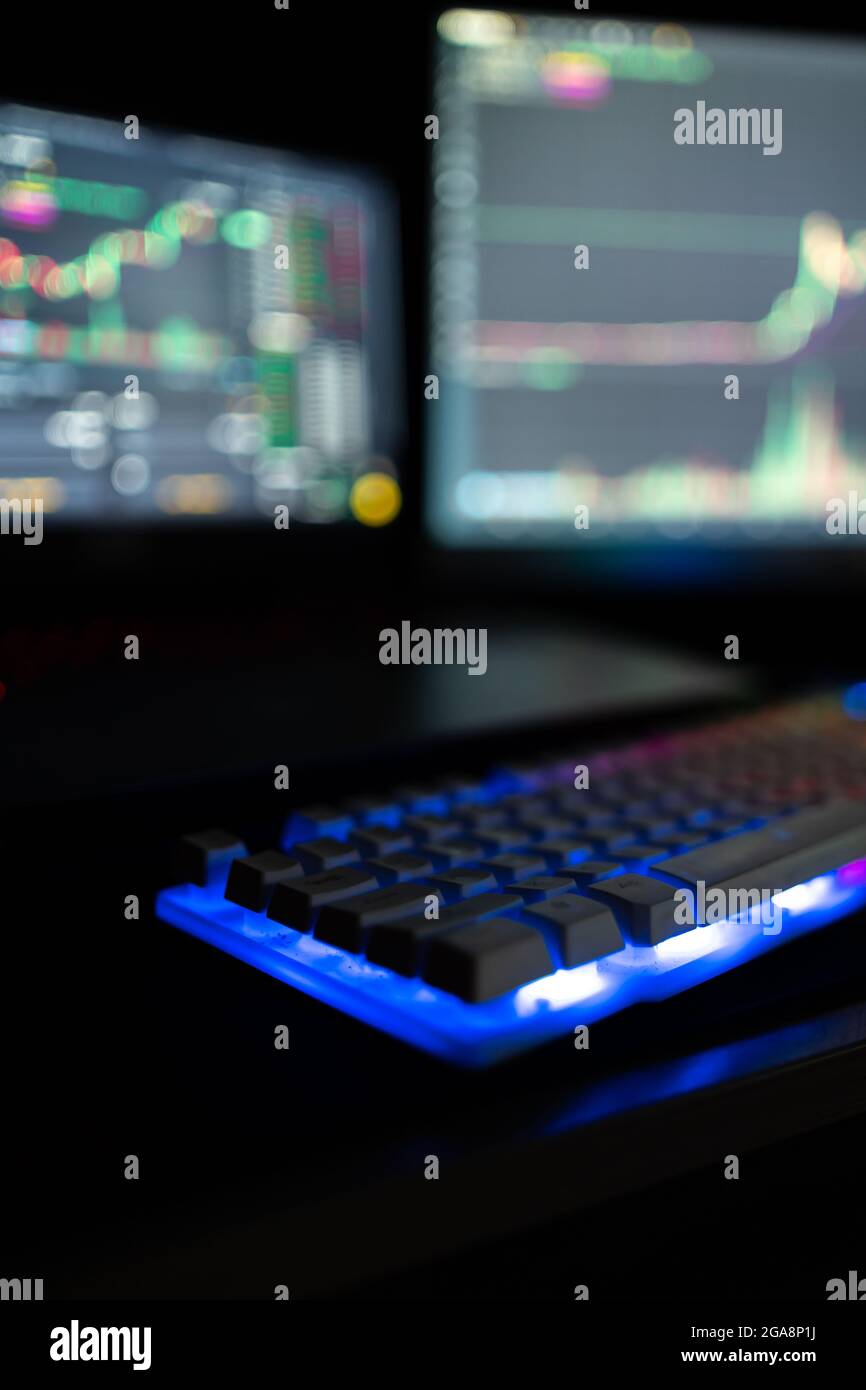 Blue keyboard with two monitors showing the Binance trading platform in ...
