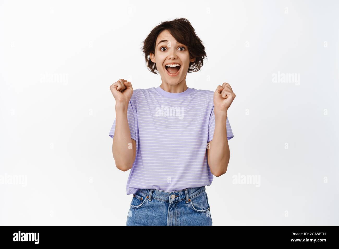 Hooray. Happy winner girl jumping excited, look surprised, winning and ...