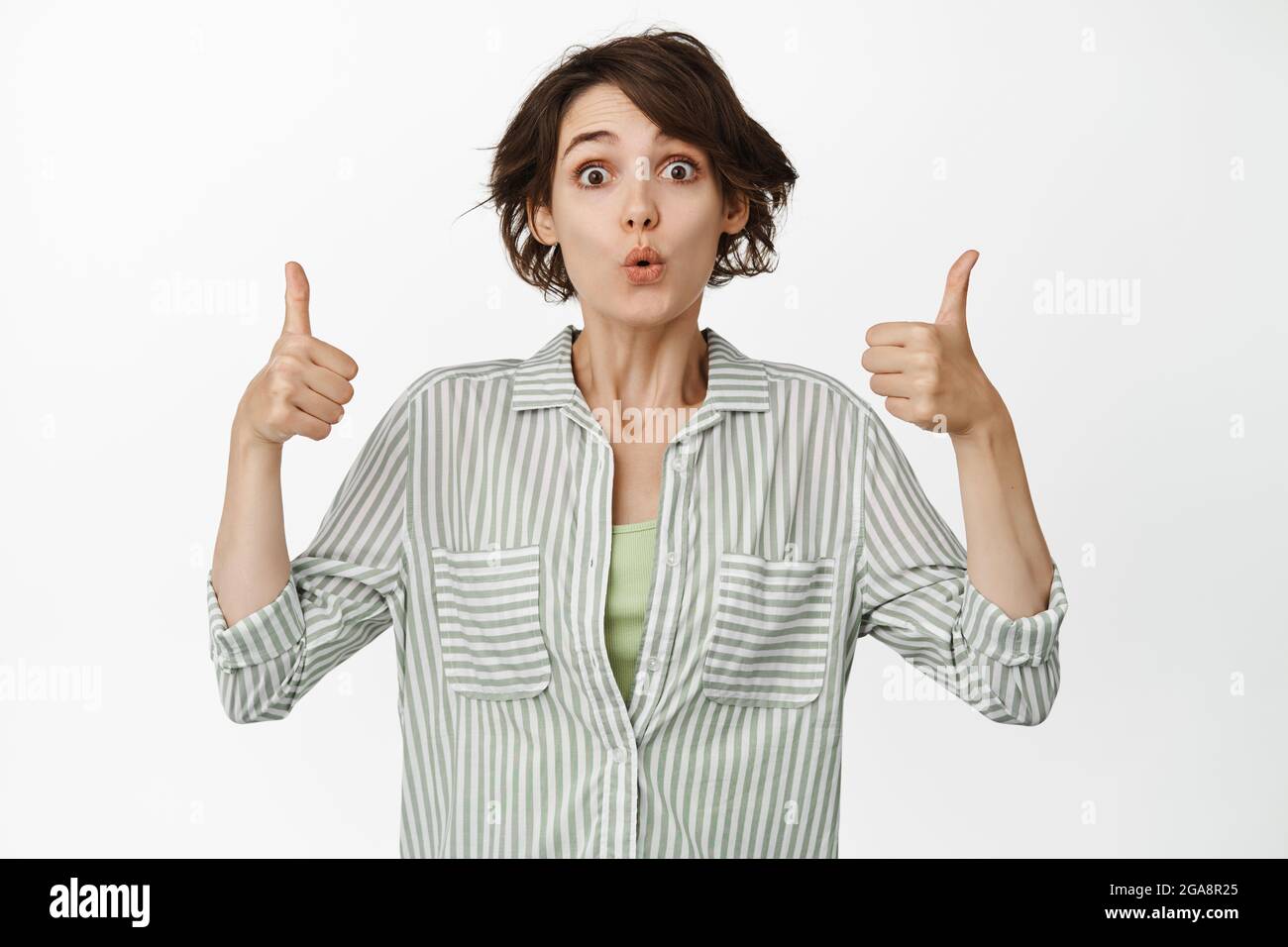 Wow awesome. Impressed girl shows thumbs up, recommending, sharing ...