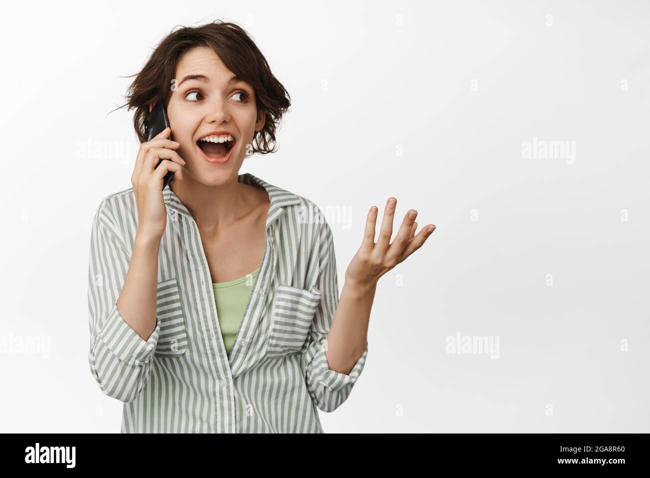 Happy modern girl talking on mobile phone, smiling and looking ...