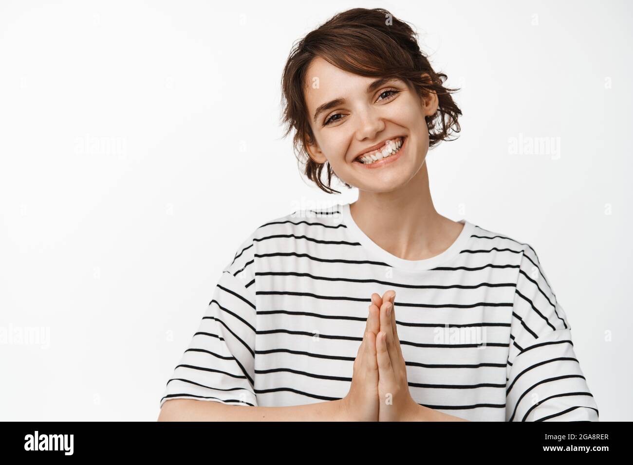 Thank you, namaste. Smiling friendly-looking girl showing pray ...