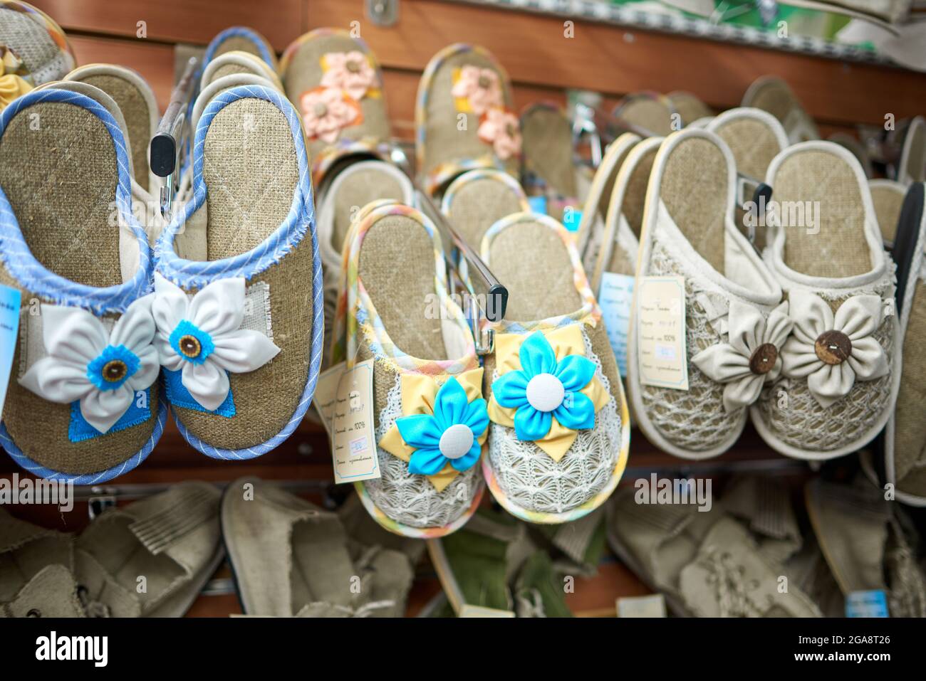 Many home slippers decorated with fabric flowers Stock Photo - Alamy