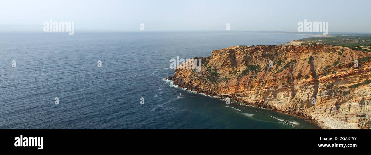 Coastal cliffs of the promontory above the cove, panoramic shot, Cape ...