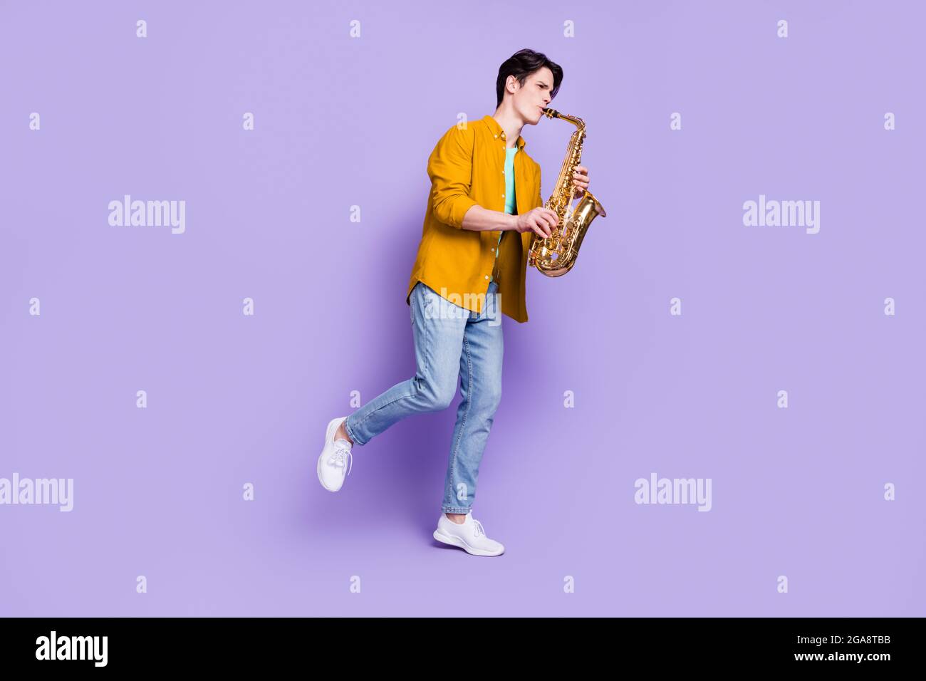 Full body profiile photo of nice brunet millennial guy play saxophone ...