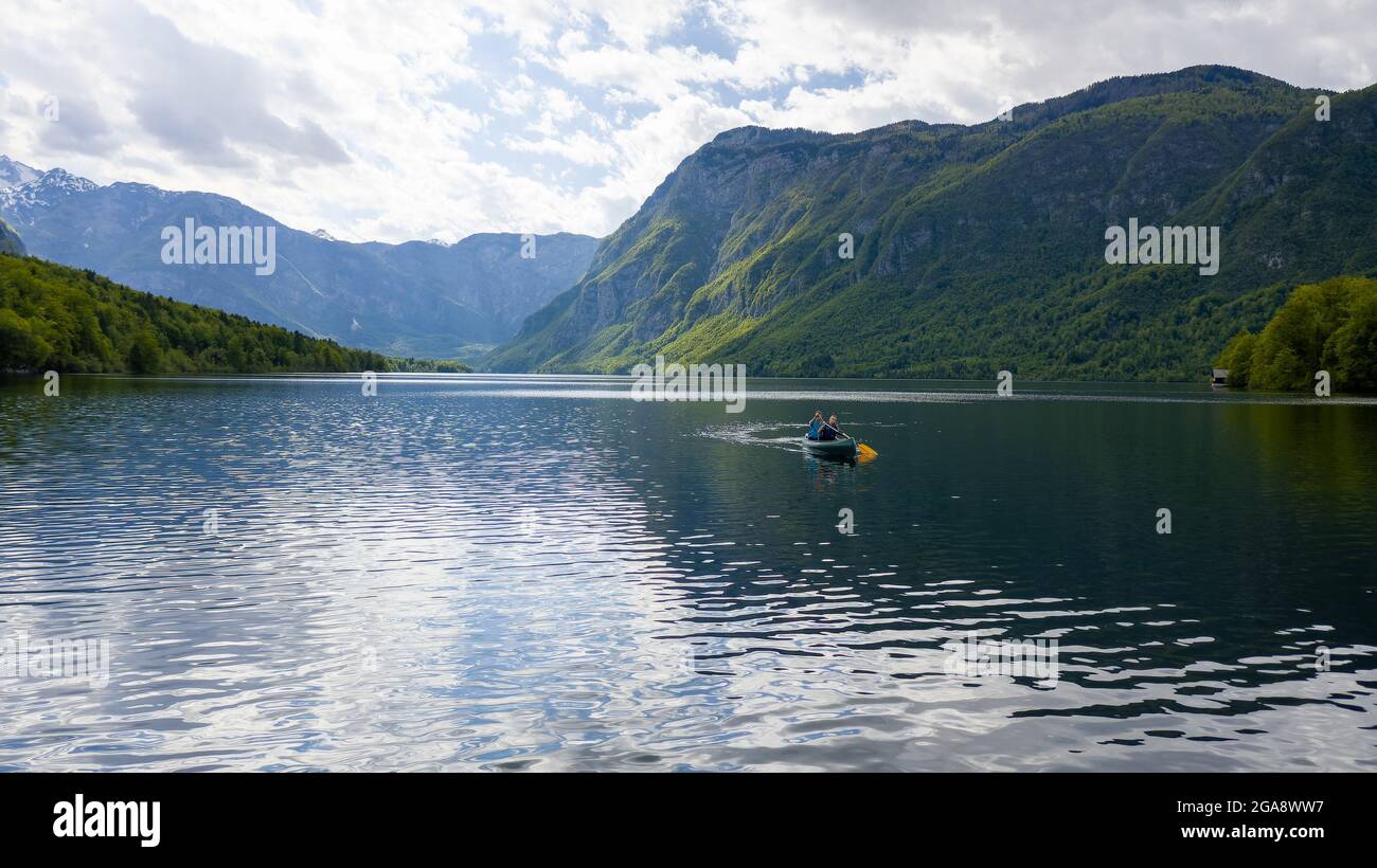 Aerial bird eye shot of a canoe with two person paddling, on beautiful ...