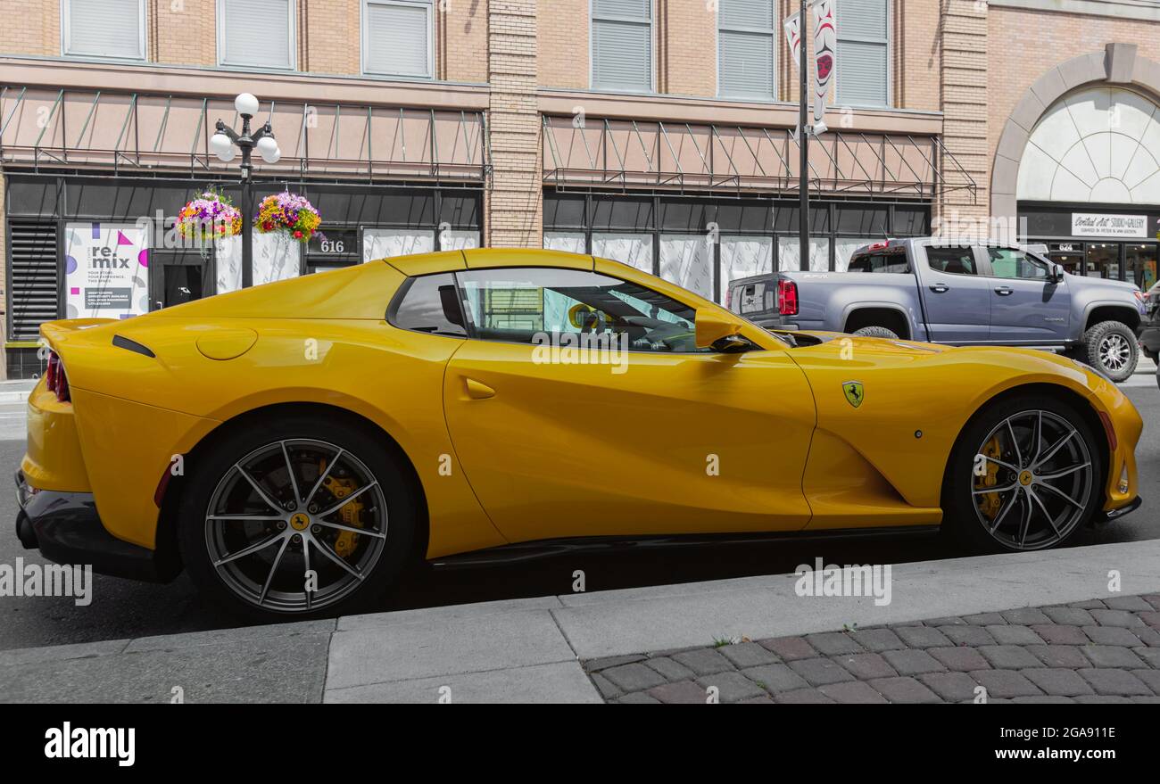 Side view of a yellow Ferrari 812 superfast parked on the street of ...