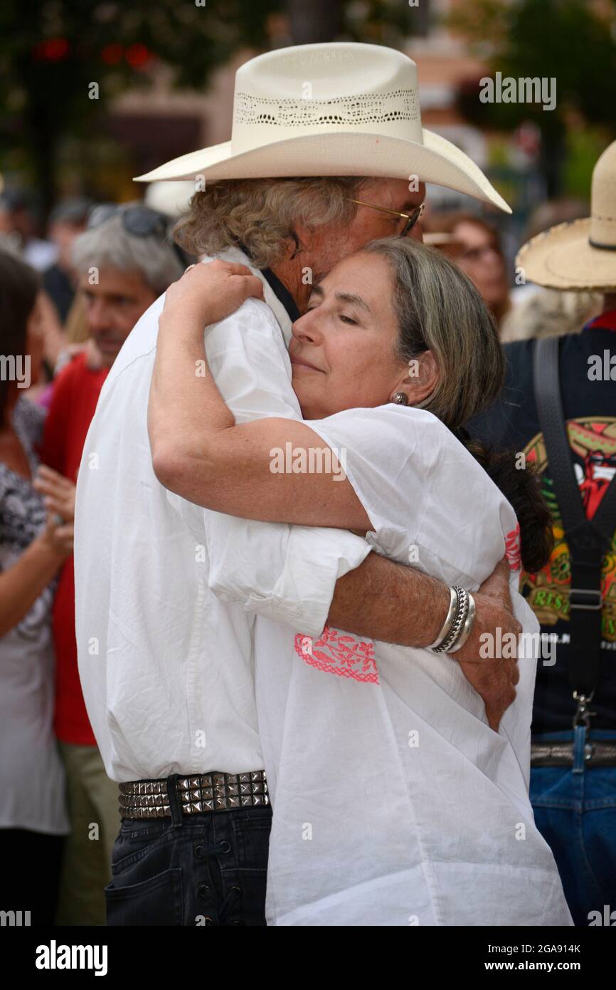 A couple enjoy dancing to the music of a live band performing on the ...