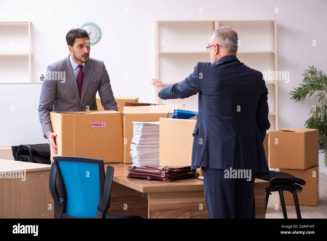 Two employees in relocation concept Stock Photo - Alamy