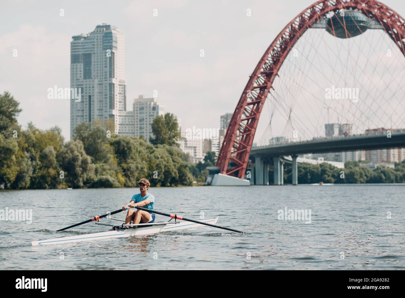Sportsman single scull man rower rowing on boat at Moscow River Russia ...