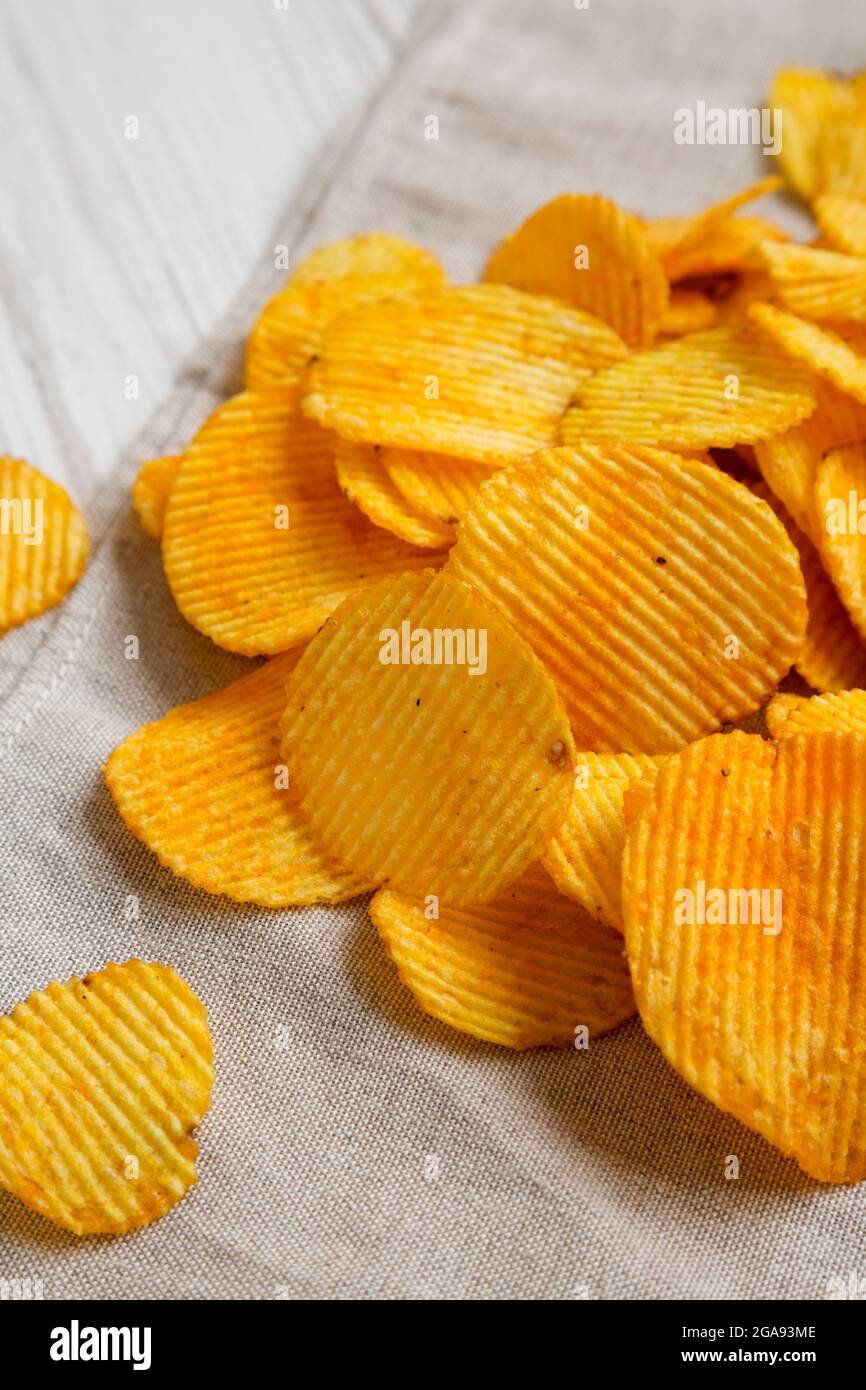 Ruffled Cheese Potato Chips, side view. Close-up Stock Photo - Alamy