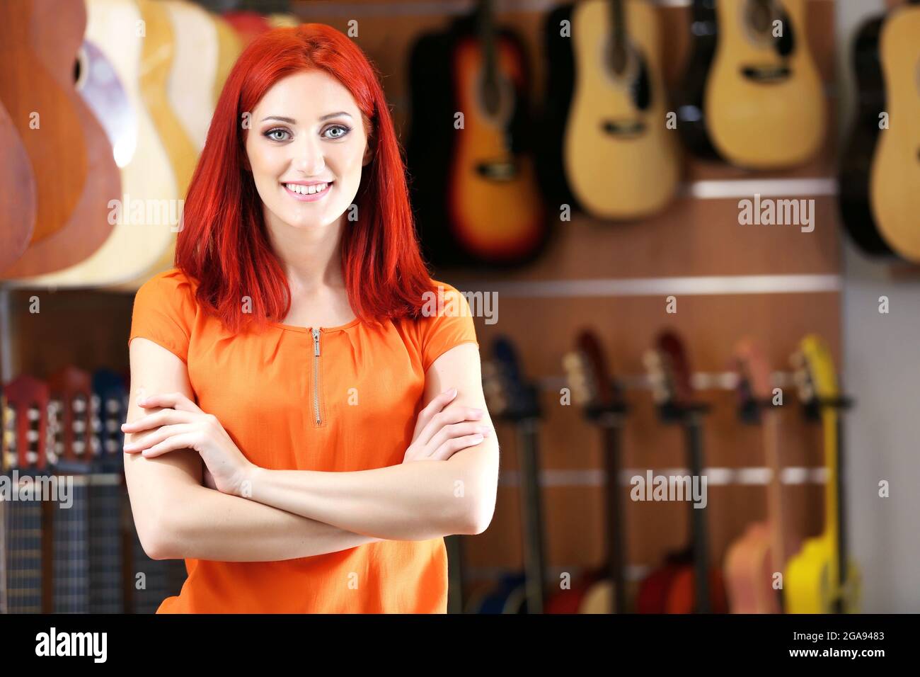 Beautiful young woman in music store Stock Photo - Alamy