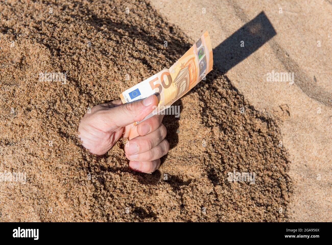 Man buried in the sand hi-res stock photography and images - Alamy