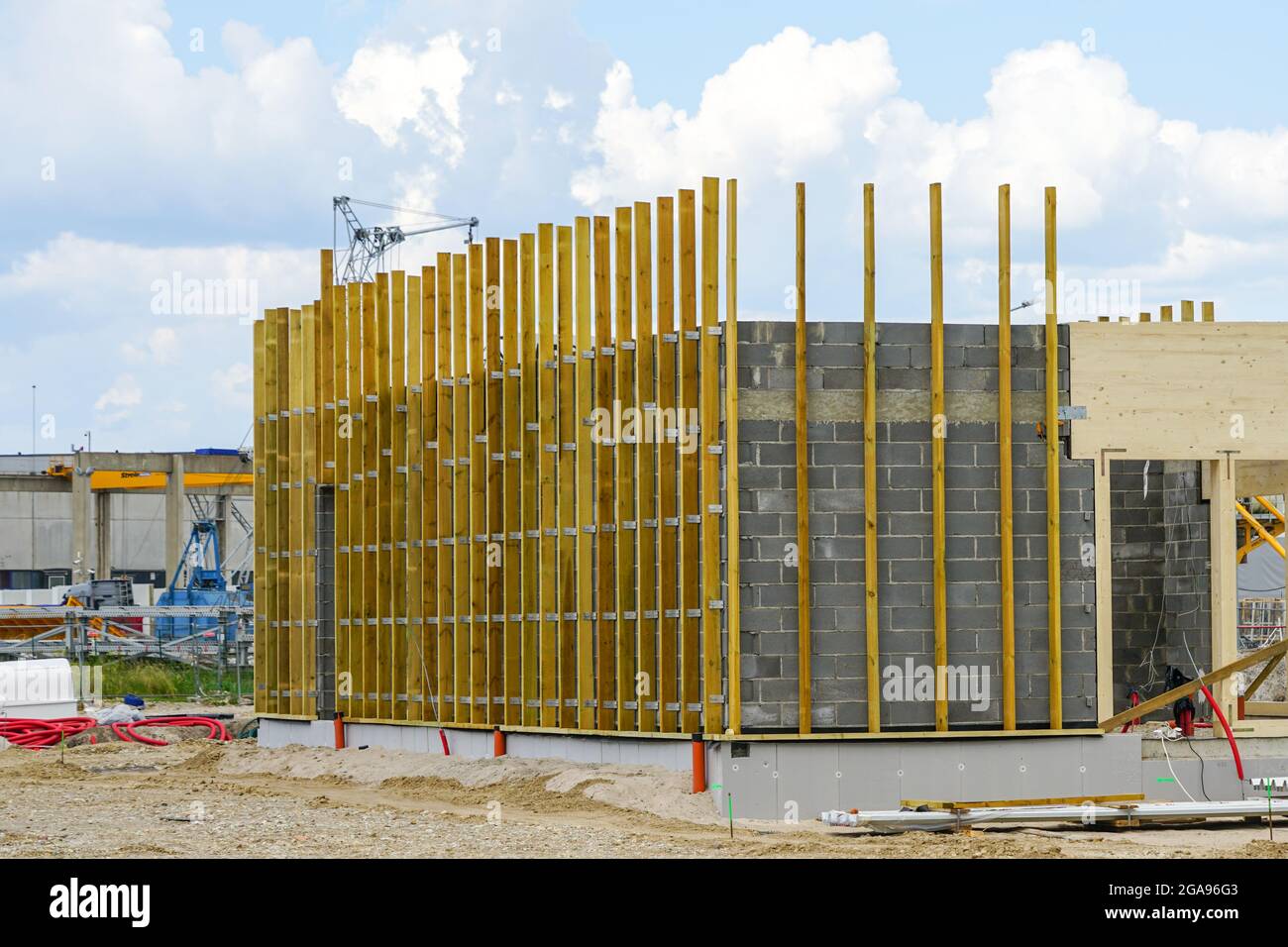 the facade of a new building built of building blocks with wooden laths ...