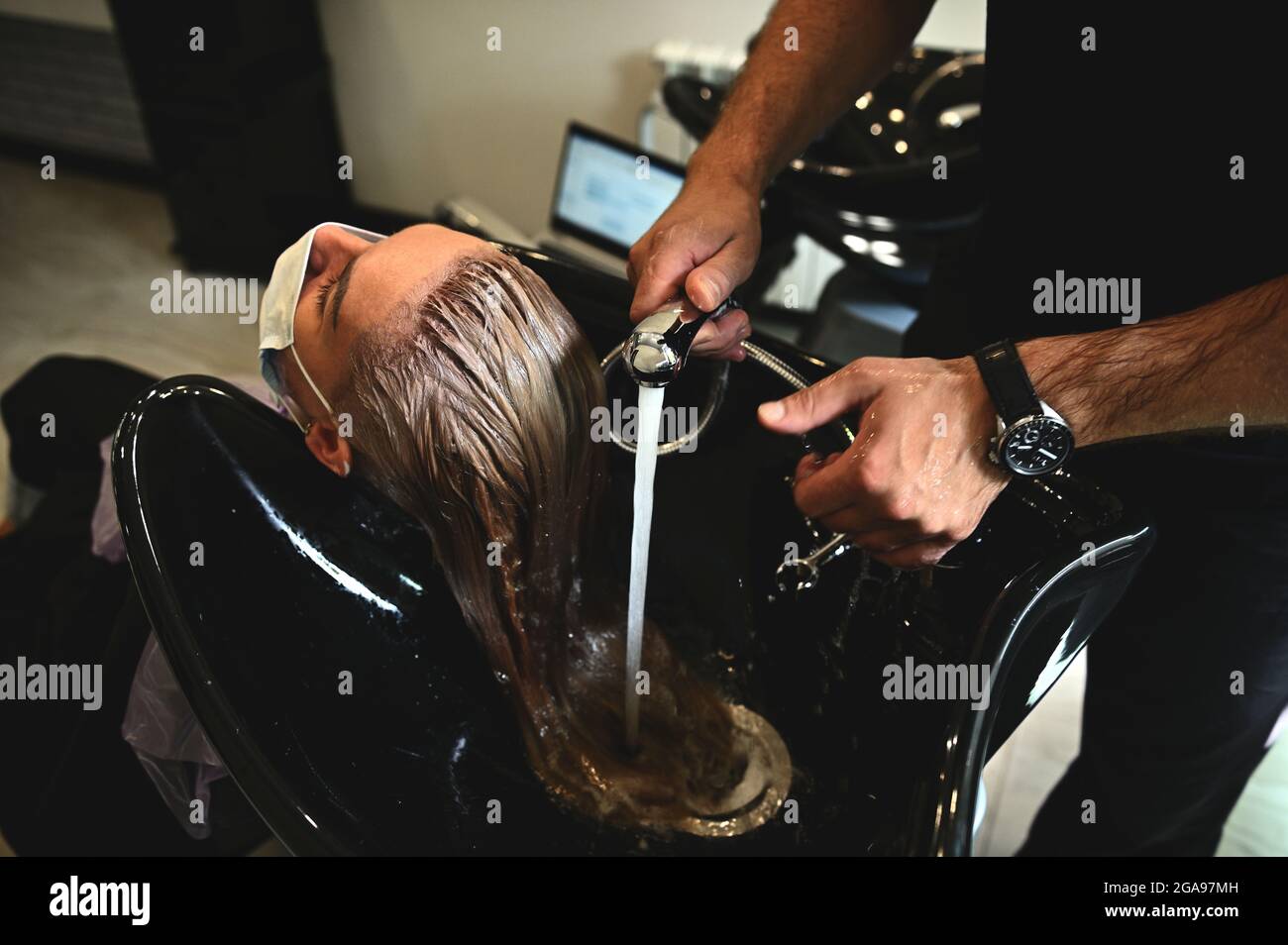 Beautician washing hair color off hi-res stock photography and images ...