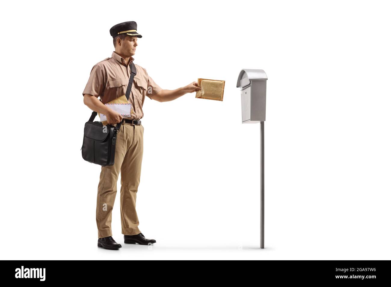 Full length shot of a mailman in a uniform putting a letter into a mail ...